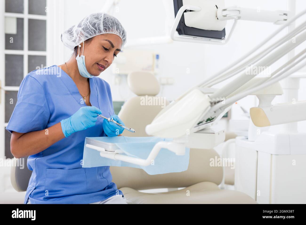 Portrait of professional female stomatologist preparing sterile dental ...