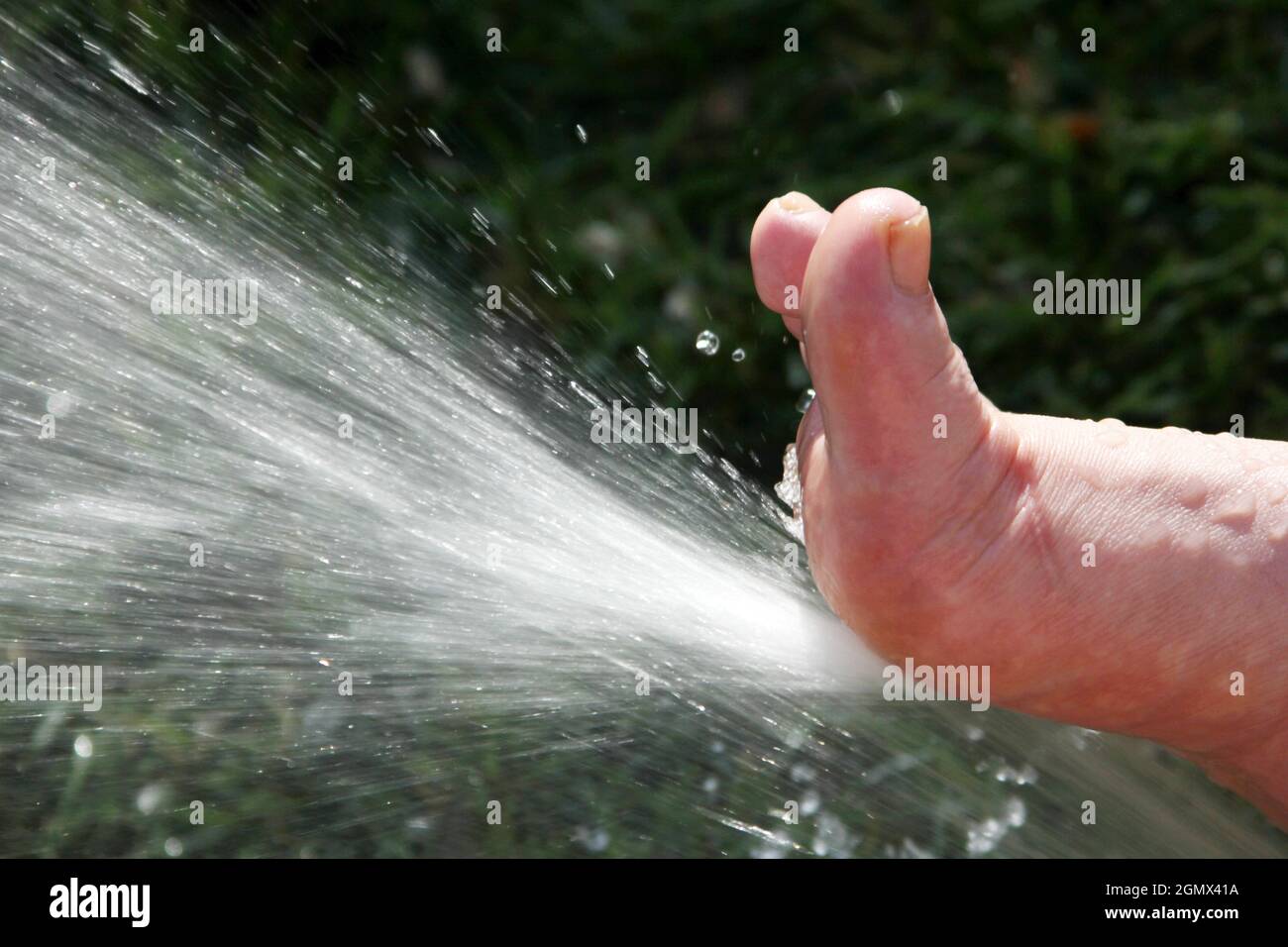 cooling your feet with the sprinkler Stock Photo - Alamy
