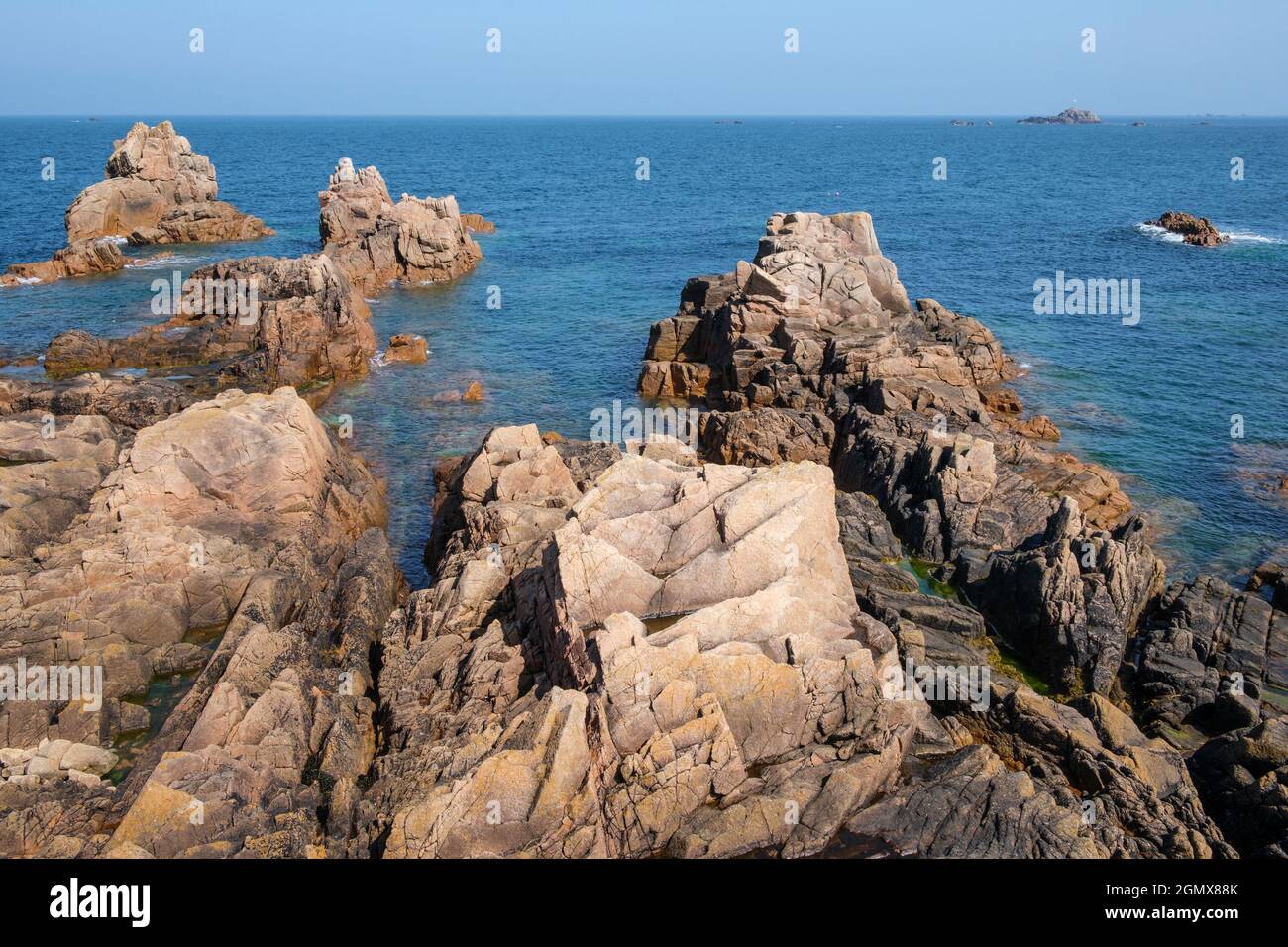 The rocky coast at Fort Hommet, Vazon Bay, Guernsey, Channel Islands ...