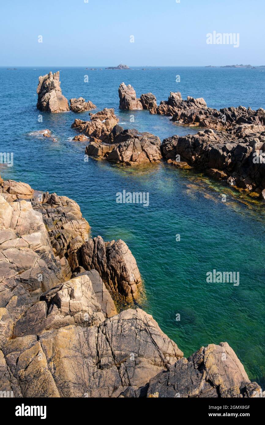 The rocky coast at Fort Hommet, Vazon Bay, Guernsey, Channel Islands ...