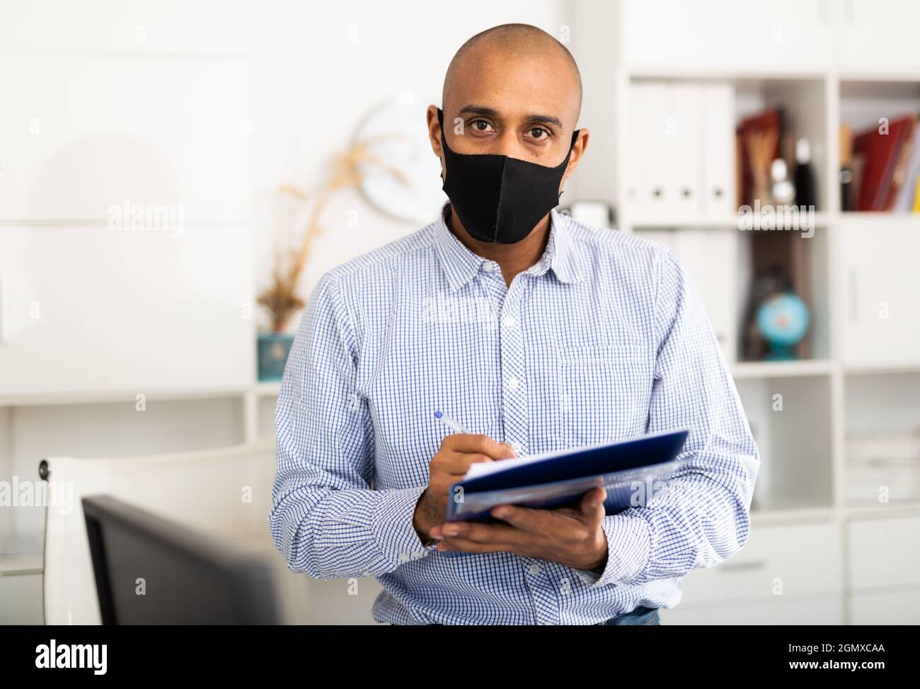 Viral threat, seasonal viral diseases. Man works in the office in a ...