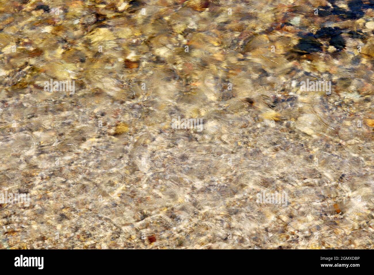 Clear water flowing through the pebbles in the creek Stock Photo - Alamy
