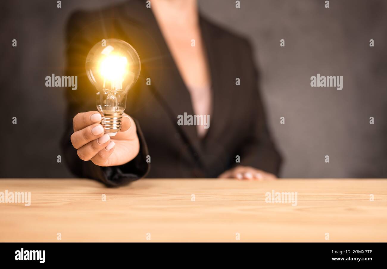 Business women holding light bulbs, new ideas with innovative ...