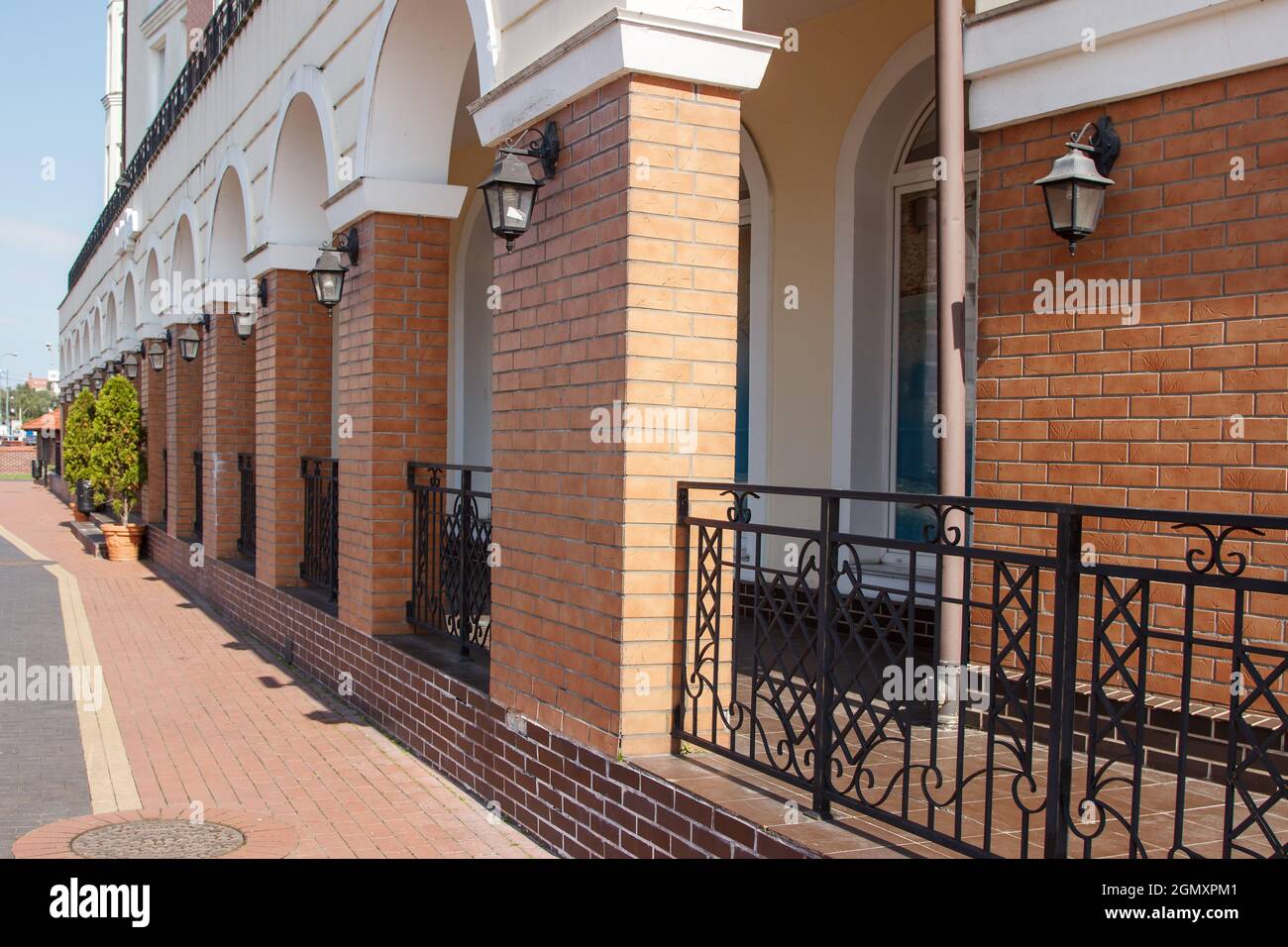 decorative brick colonnade of modern city building on sunny summer day ...