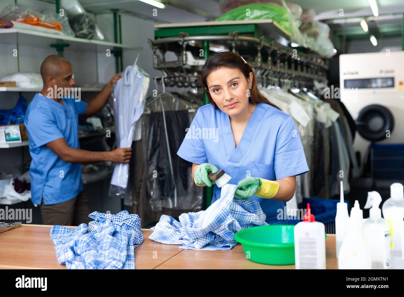 Experienced woman working in modern dry cleaner Stock Photo - Alamy