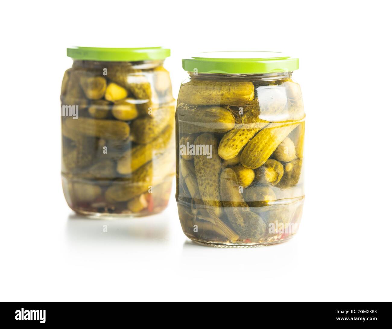 Small pickles. Marinated pickled cucumbers in jar isolated on white ...