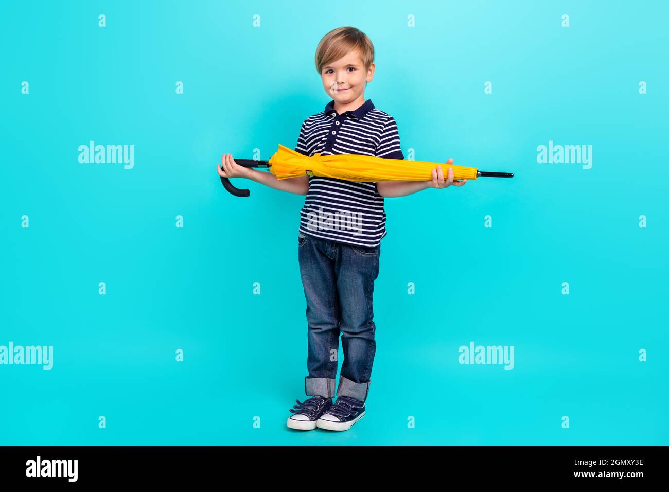 Full length photo of sweet small boy hold umbrella wear t-shirt jeans ...