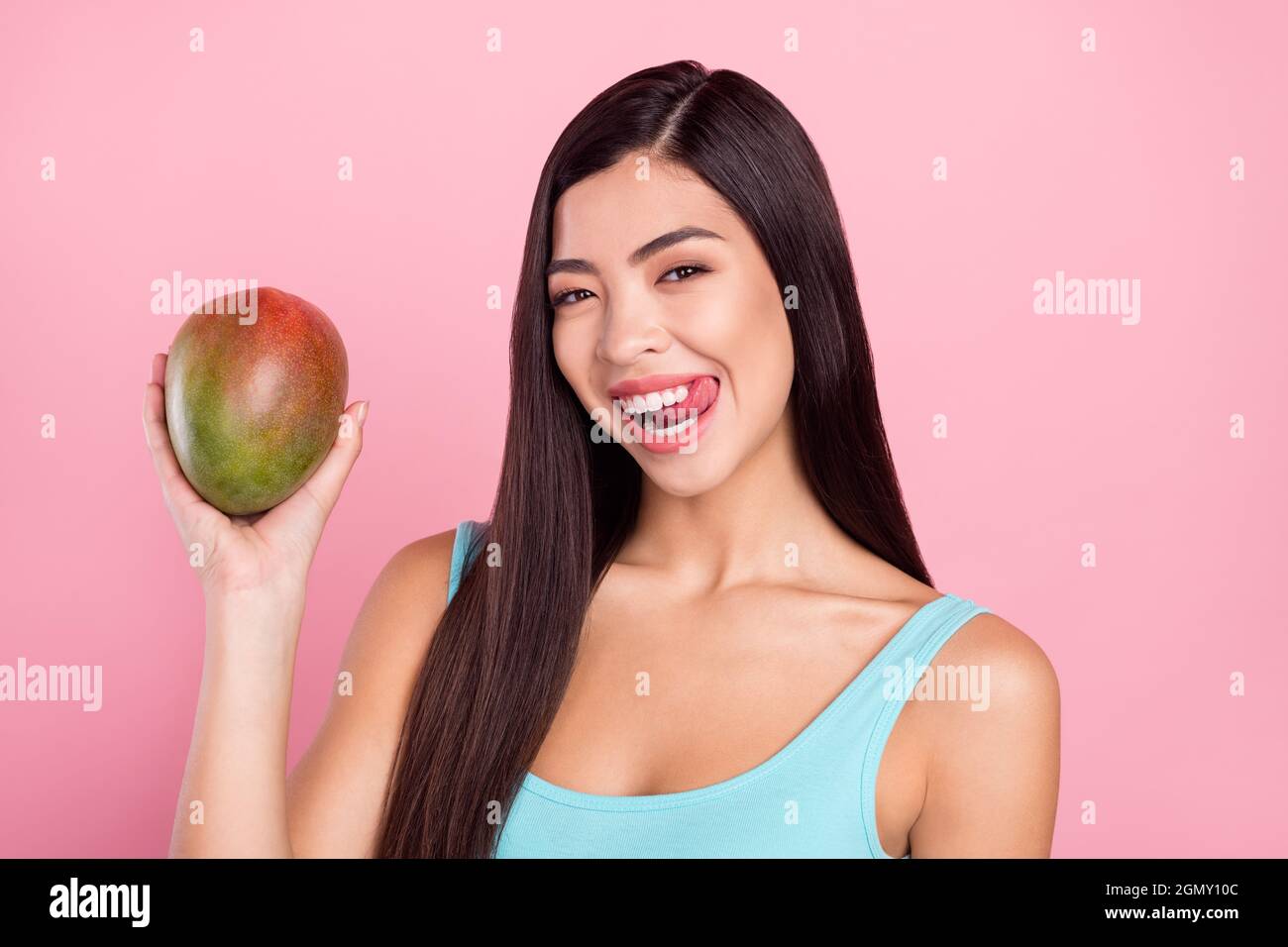 Photo portrait woman smiling keeping exotic fruit licking lips hungry ...