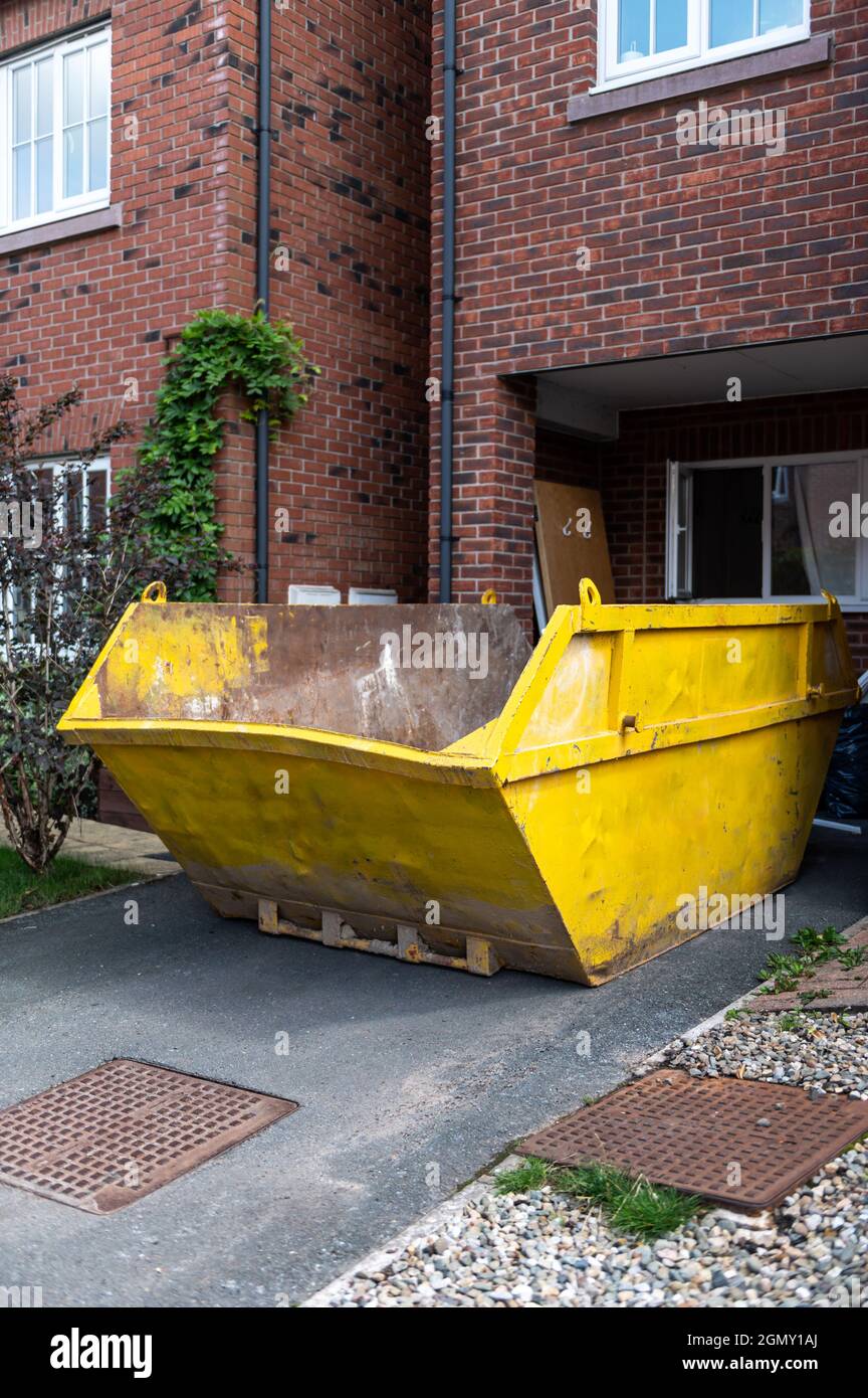 Big Yellow rubbish skip Stock Photo - Alamy