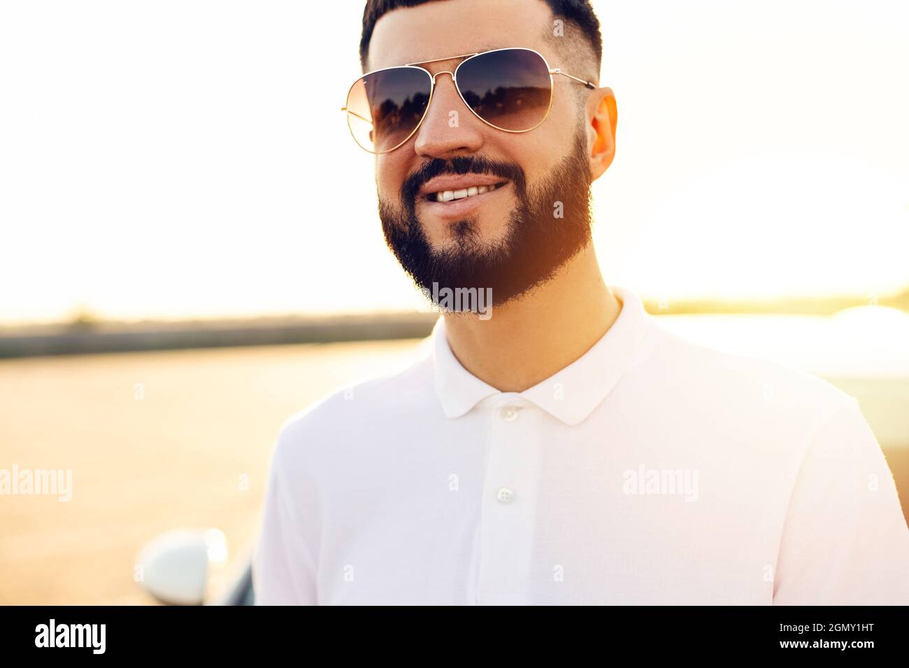 Stylish young man with a beard, in sunglasses, Handsome and charming ...