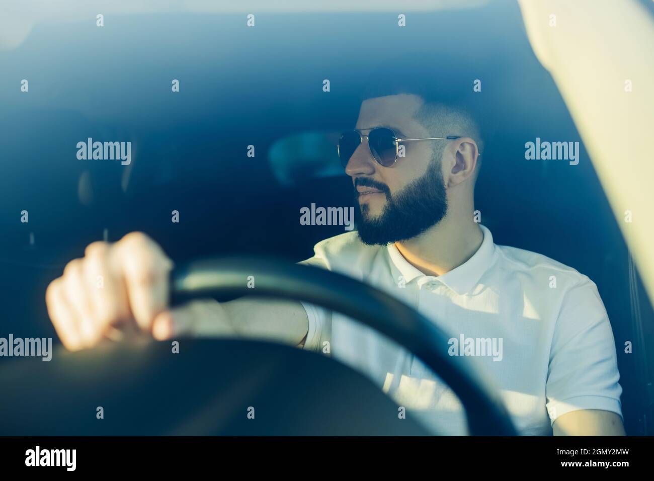 Focus on the road, Front view, young handsome man looking straight ...