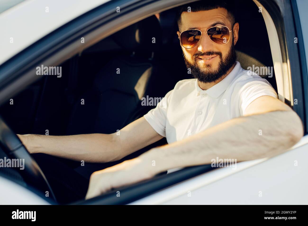 Focus on the road, Front view, young handsome man looking straight ...