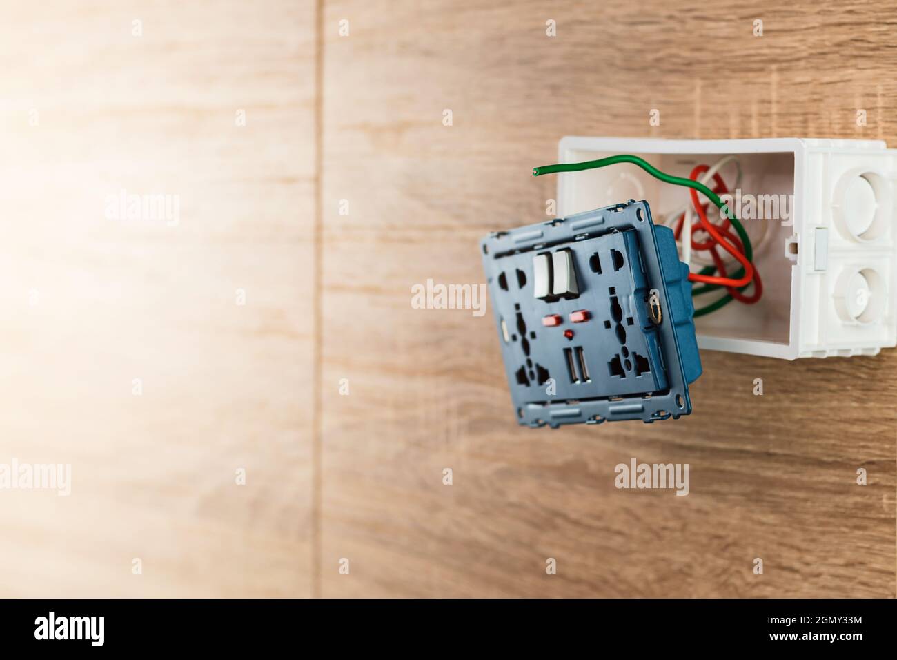 Universal wall outlet AC power plug with USB port in a plastic box on a ...