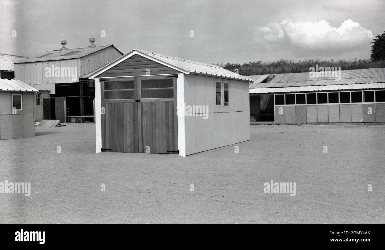 1950s, historical, outside on a wide, level area at a light industrial ...