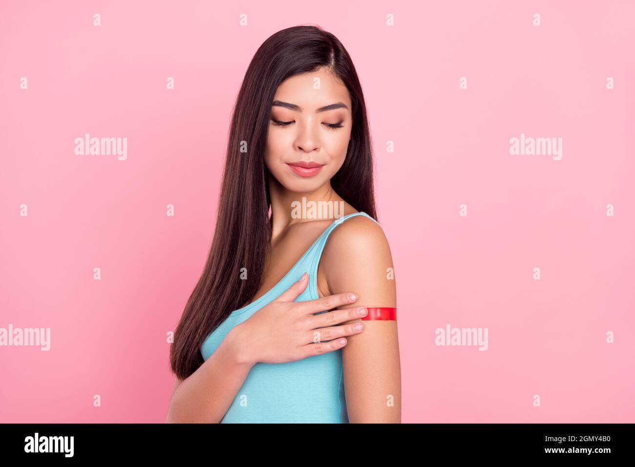 Photo of serious lady look touch plaster wear blue top isolated on pink ...