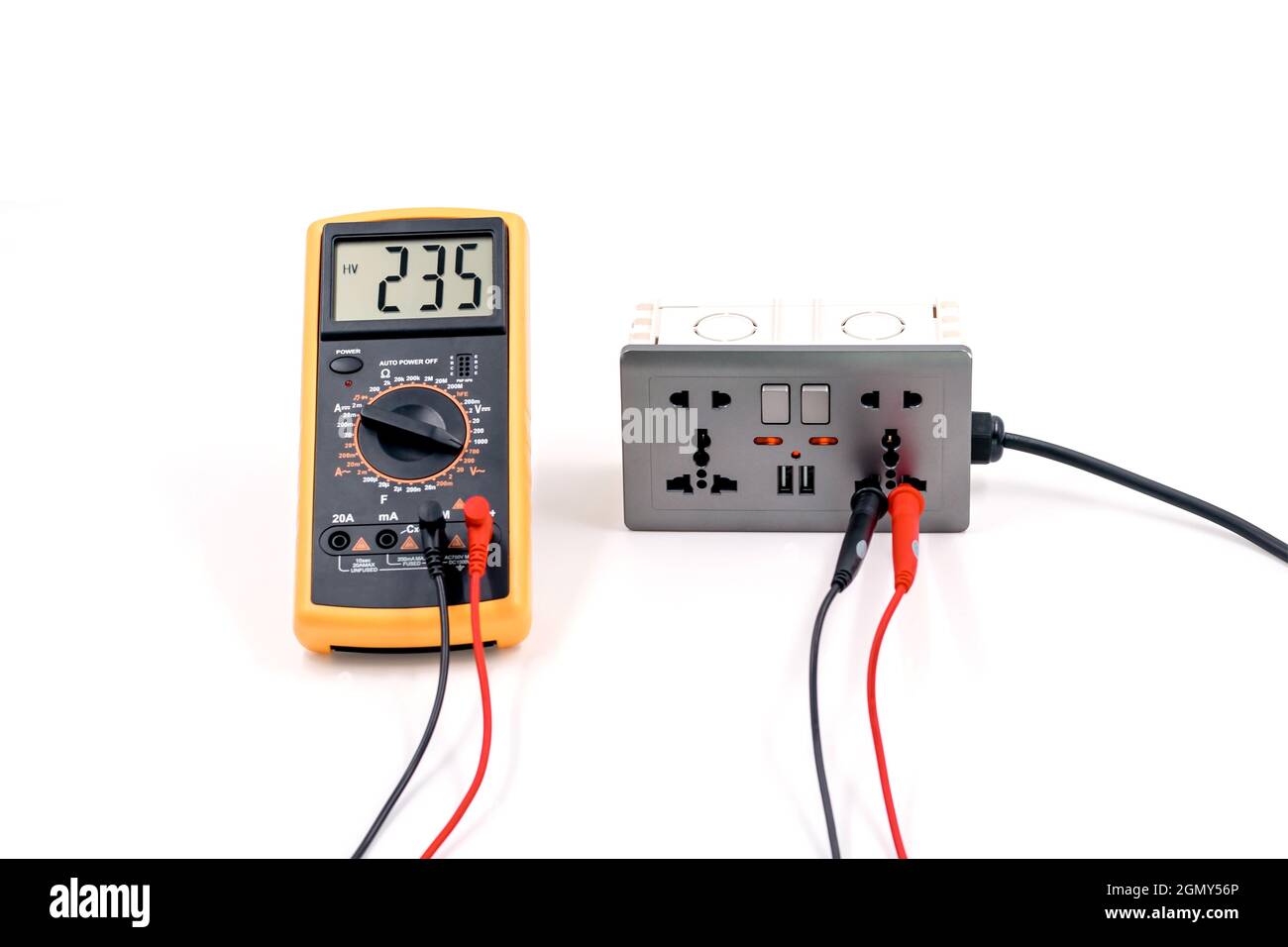 Using a digital meter to measure the voltage at a electric socket box ...