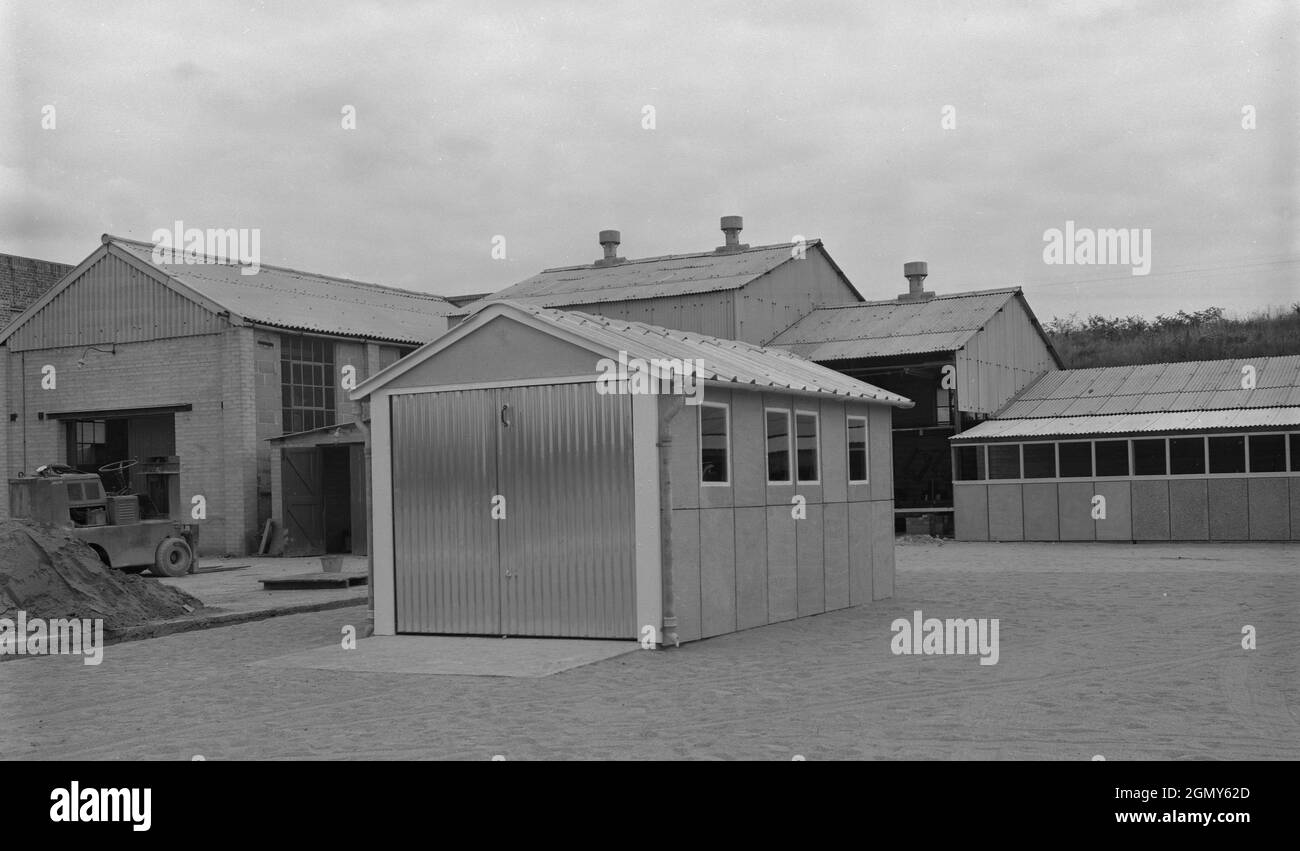 1950s, historical, outside on a wide, level area at a light industrial ...