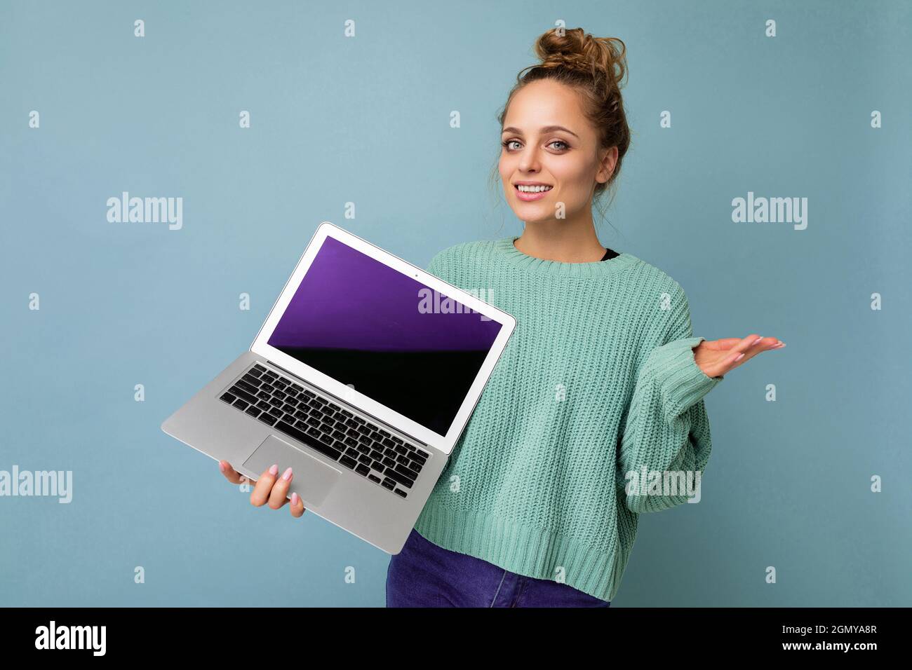 beautiful dark blond young woman with gathered curly hair looking at ...