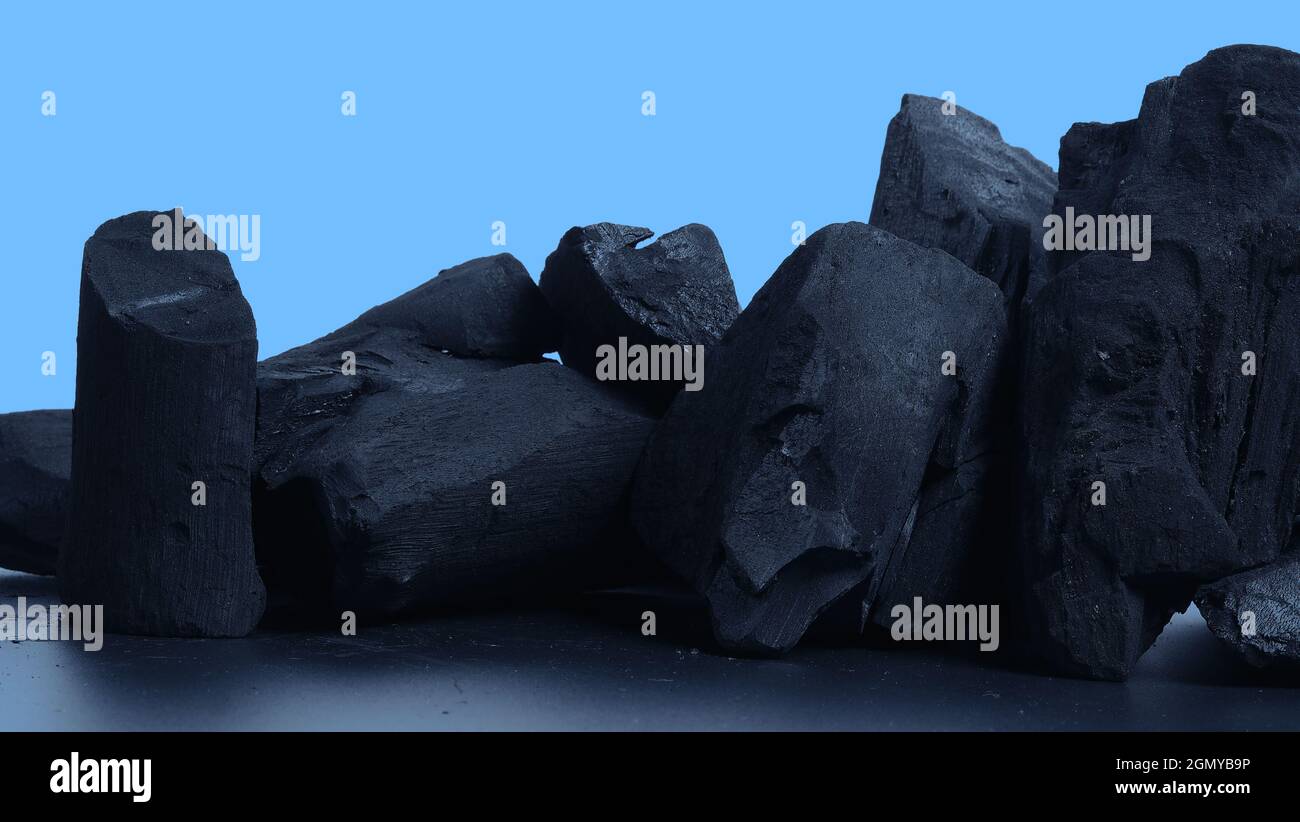 Wood charcoal. Black Charcoal on black textured floor. Used for cooking ...