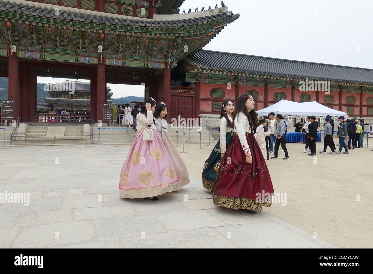 Asian students dressed for Hanbok Day pose in front of Pavilion steps ...