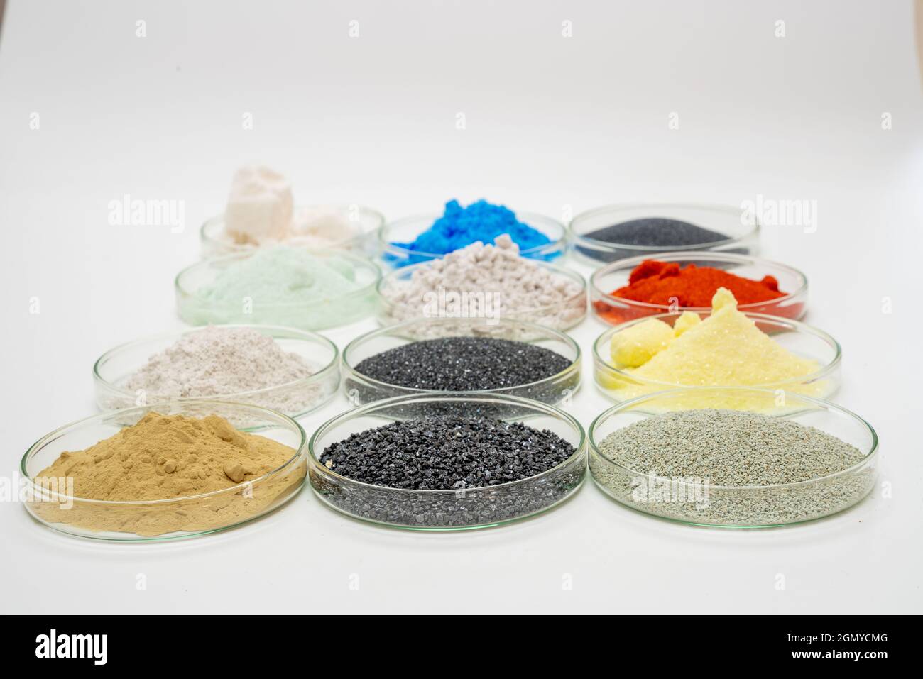 Examples of dry bulk chemical elements in petri dishes on a white ...