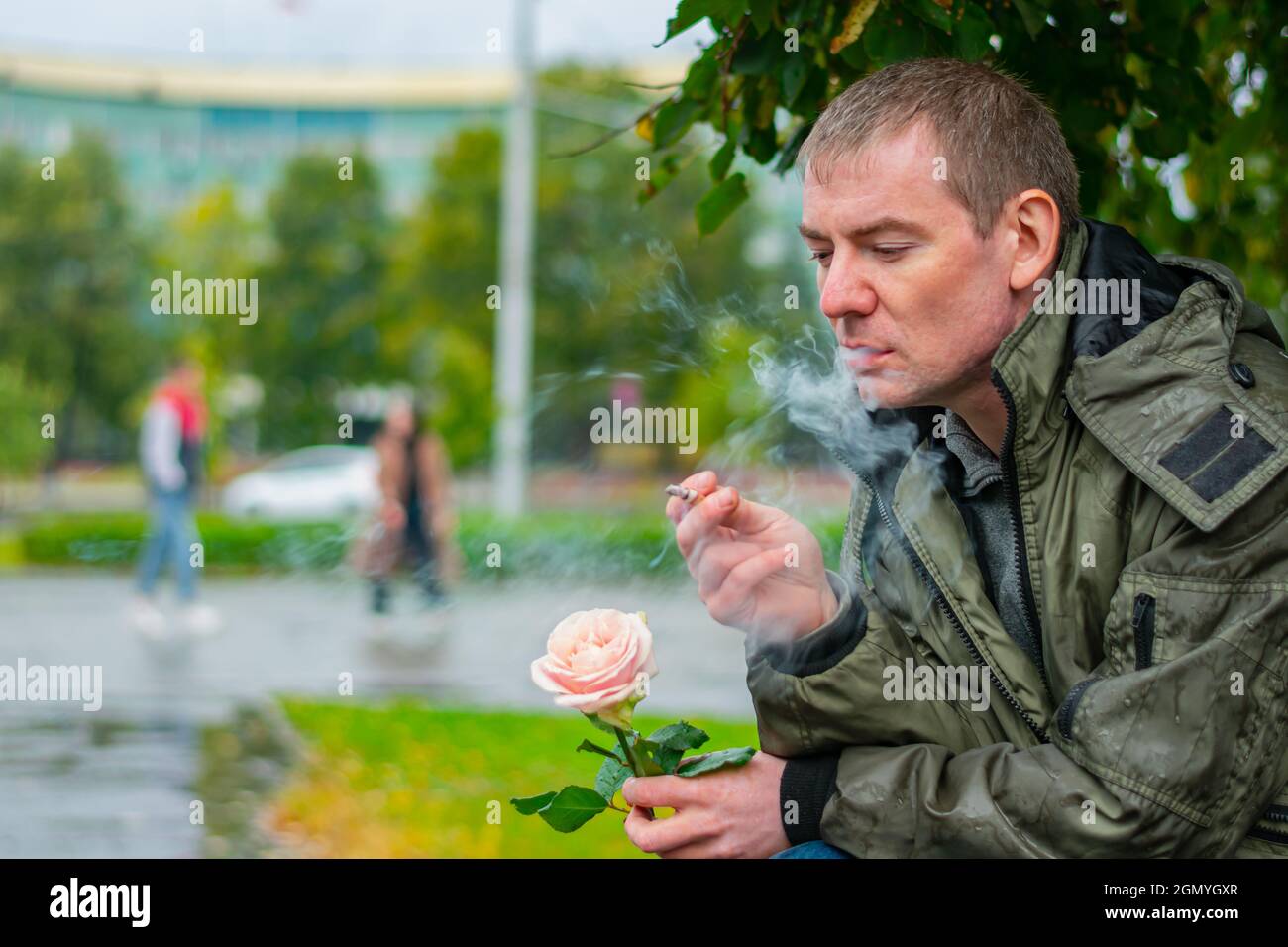 Man smoking in rain hi-res stock photography and images - Alamy