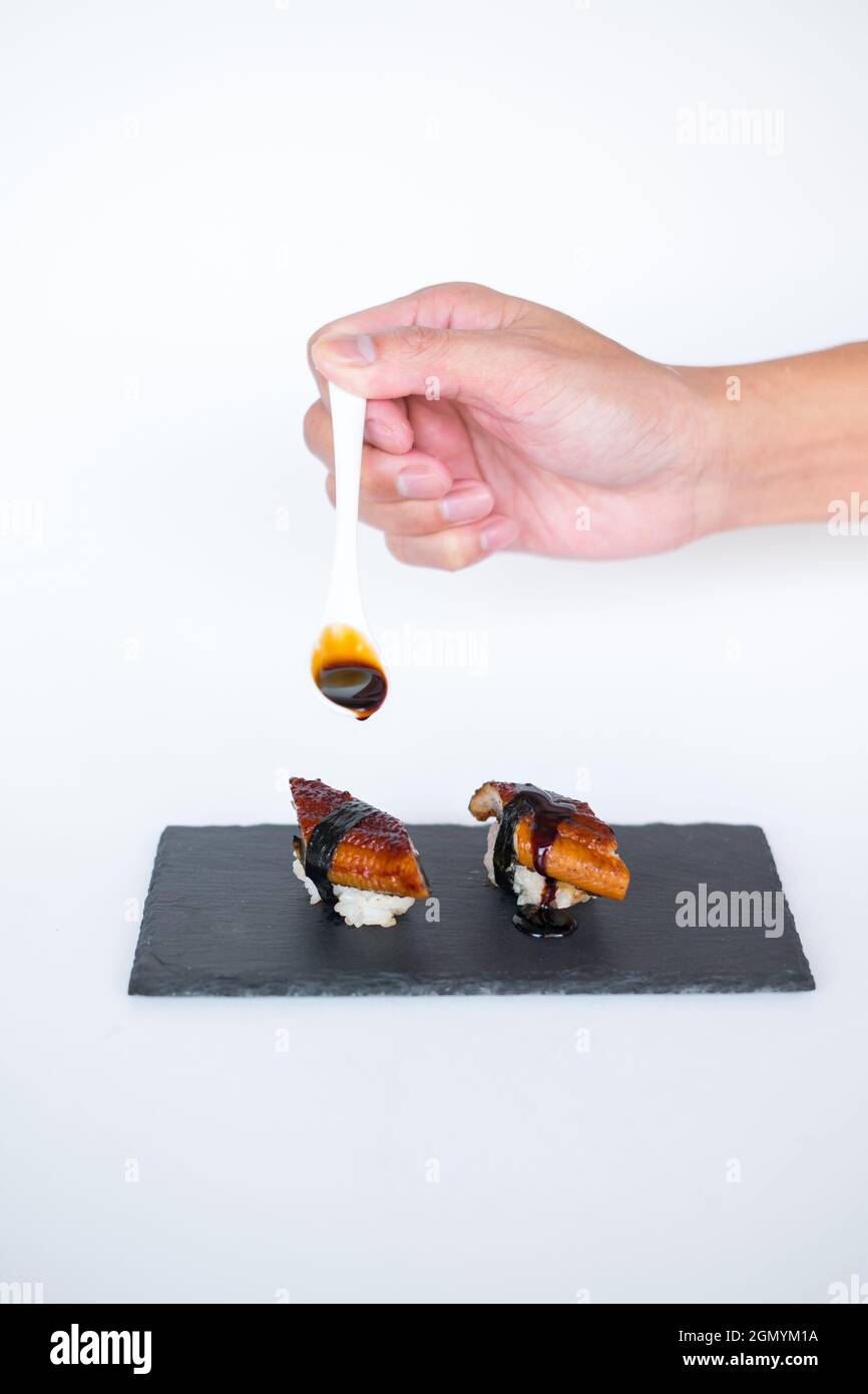 Japanese Sushi - Two Unagi Nigiri Sushi served on a black stone board. Eel Sushi. Isolated on ...