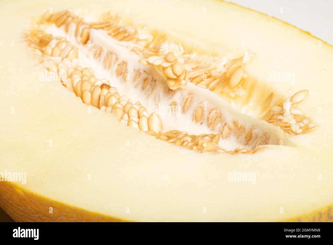 yellow ripe melon cut in half close-up, seasonal berry Stock Photo - Alamy