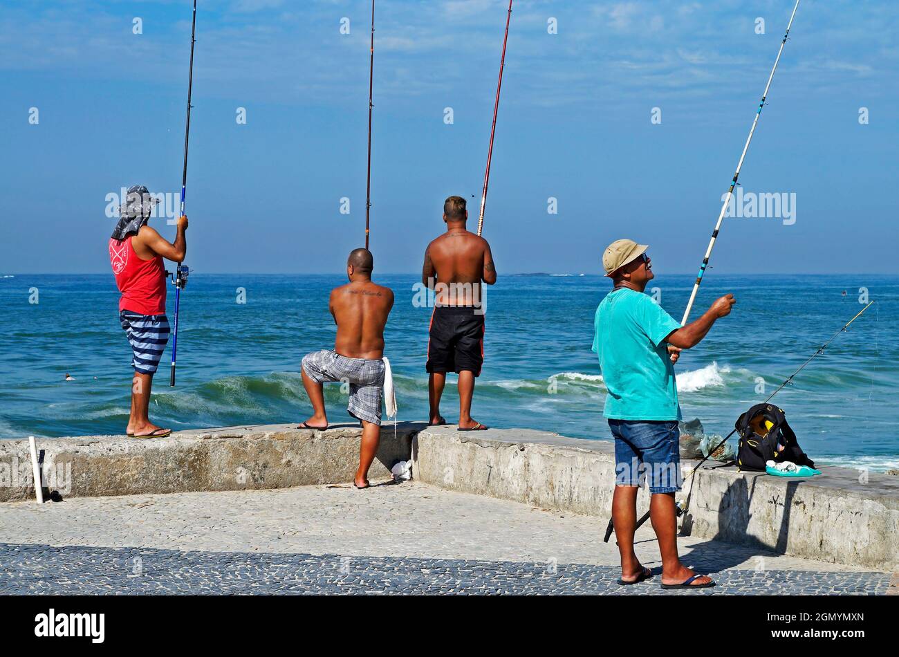 RIO DE JANEIRO, BRAZIL - MARCH 25, 2017: Men fishing at Barra da Tijuca ...