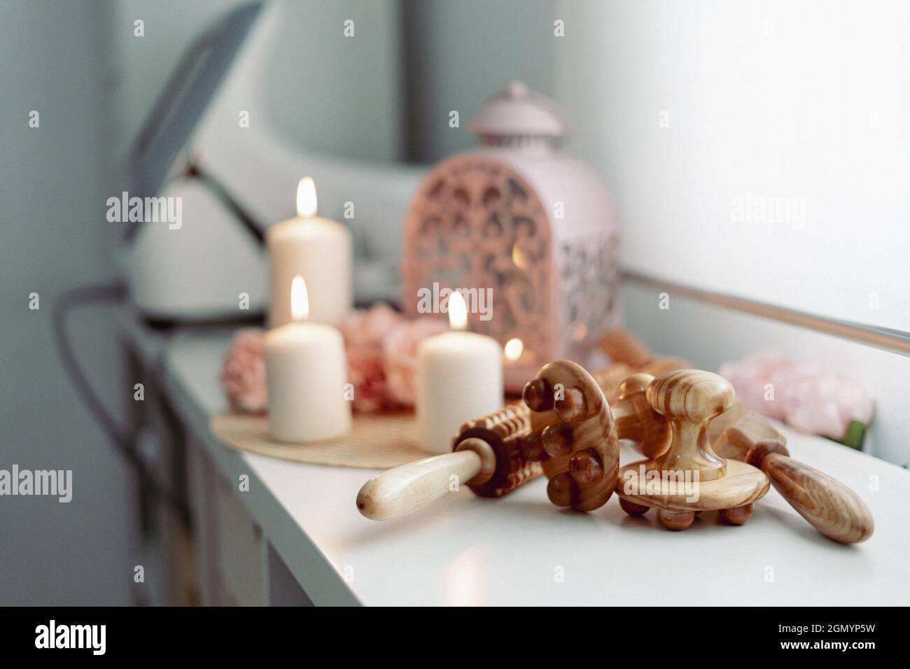 Scented candles and a set of wooden tools for massage Stock Photo - Alamy