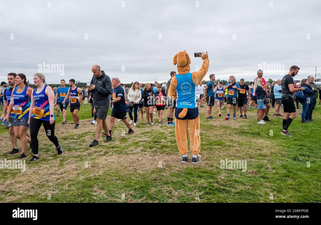 Runner in a fancy dress costume getting ready to participate in the ...