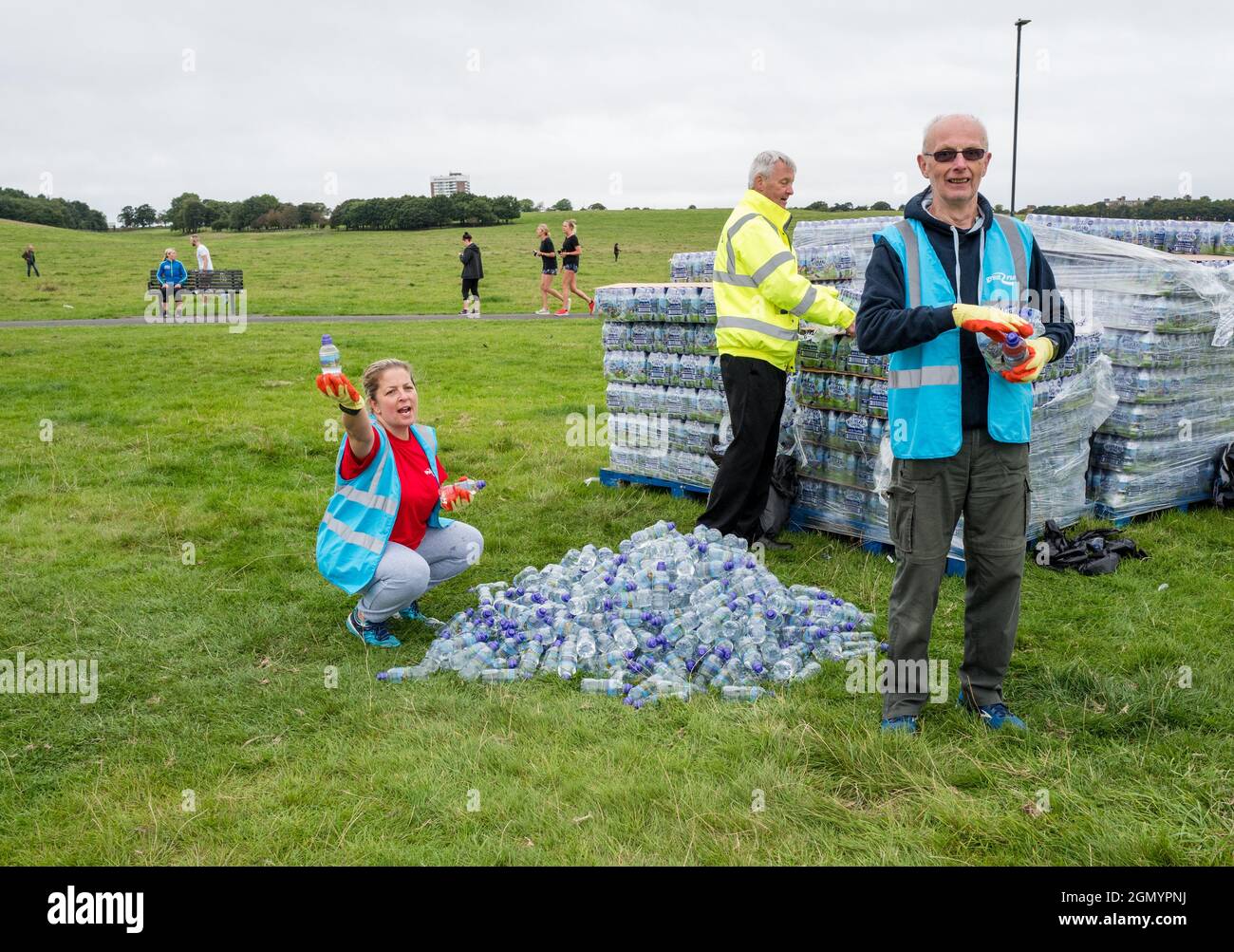 Volunteers handing out free bottles of water to competors taking part ...