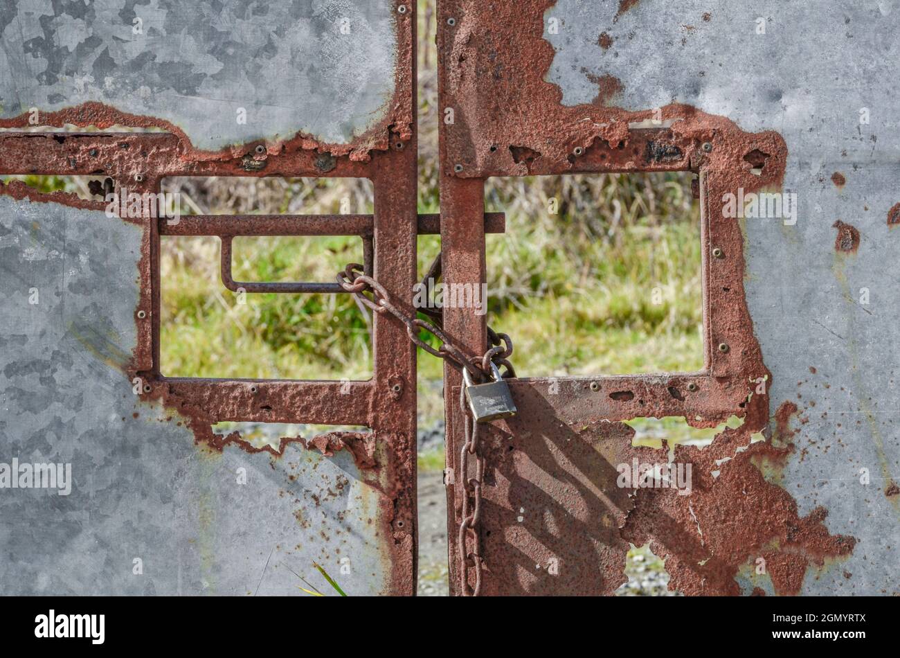 Rusty galvanized farm gate - locked with chain and padlock. Locked in ...
