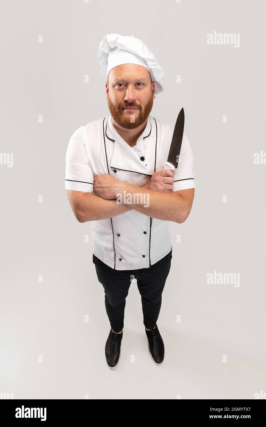 High angle view of hadsome bearded man, cook, male chef in white ...