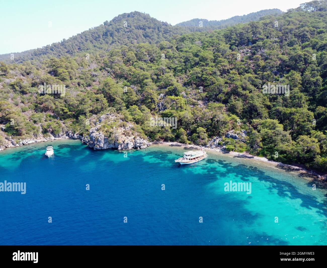 Aerial drone photo of yacht anchored in crystal clear bay and turquoise ...