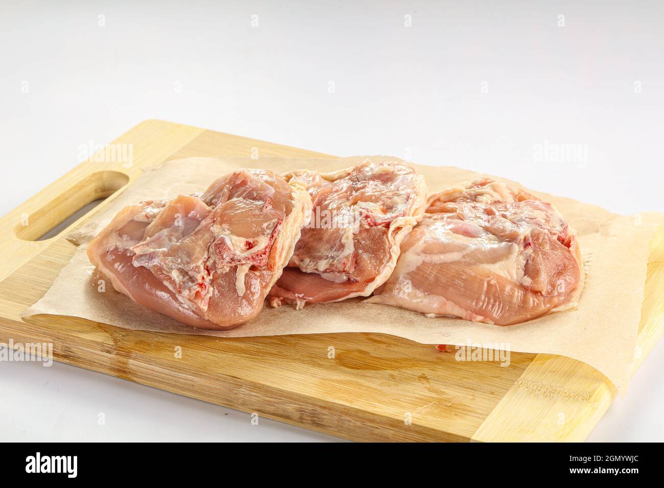 Raw chicken leg fillet uncooked over board Stock Photo - Alamy