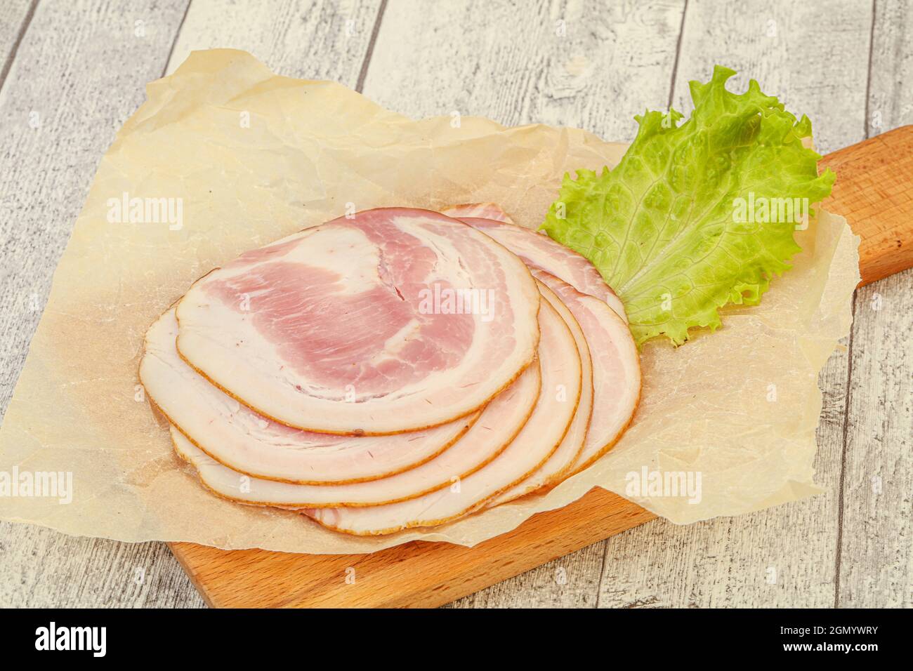 Sliced Italian Pancetta sausage over board Stock Photo - Alamy