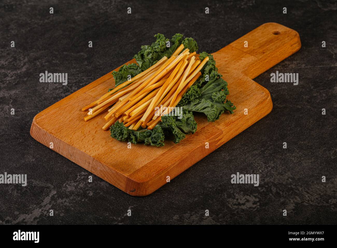 Caucasian Chechel cheese sticks over board Stock Photo - Alamy