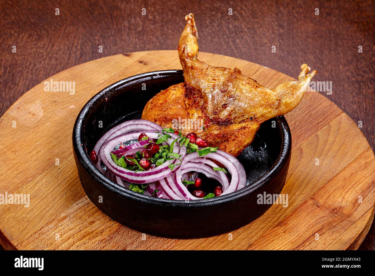Roasted quail in the pot served onion rings Stock Photo - Alamy