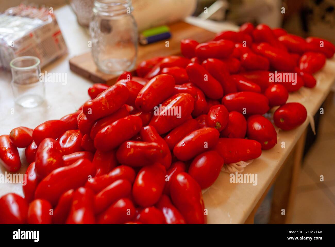 Close-up shot of a bunch of long tomatoes on a table of a kitchen Stock ...