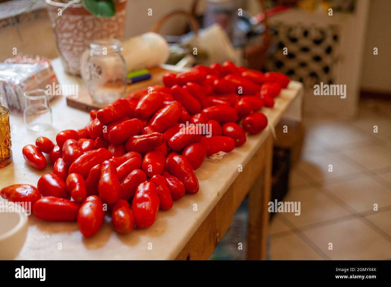 Bunch of long tomatoes on a table of a kitchen Stock Photo - Alamy