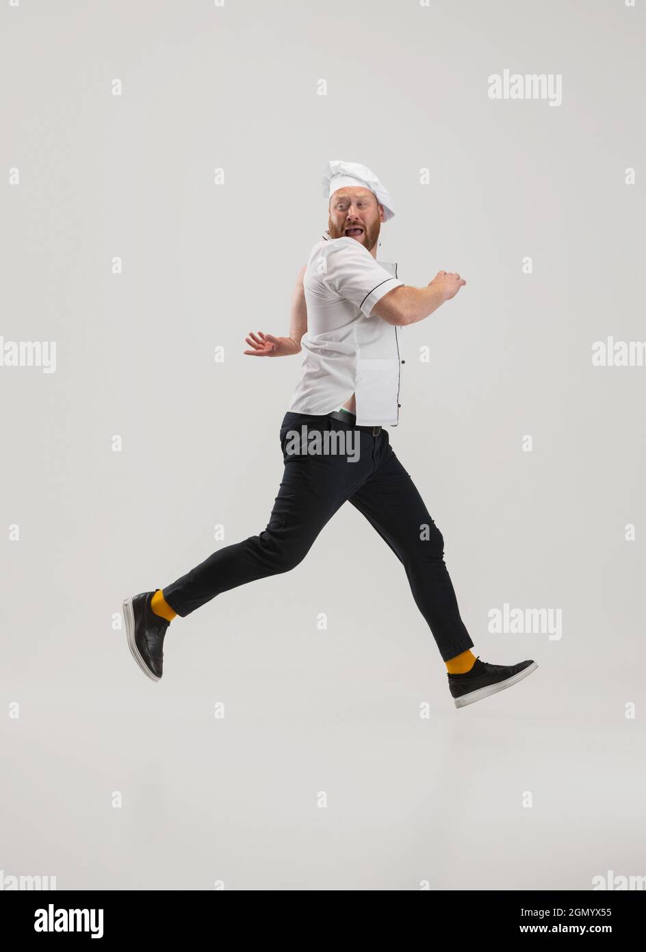 Portrait of cook, chef man in uniform running to kitchen isolated on ...