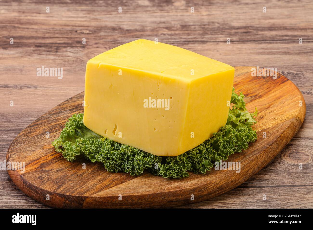 Yellow tilsiter cheese dairy product brick Stock Photo - Alamy
