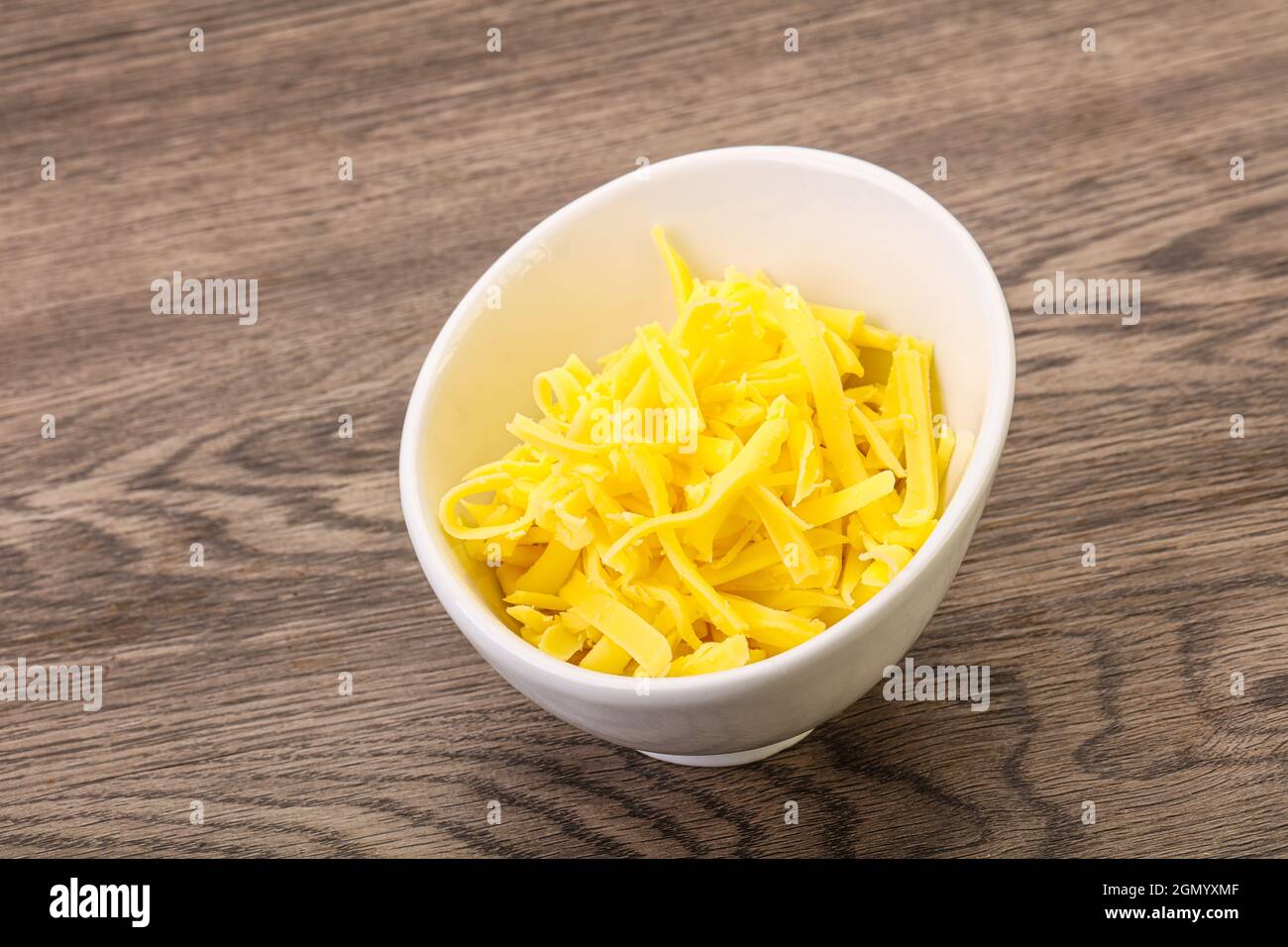 Shredded yellow cheese in the bowl for cooking Stock Photo - Alamy
