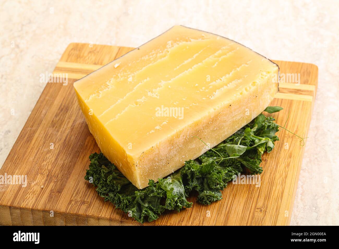 Hard Parmesan cheese piece over board Stock Photo - Alamy