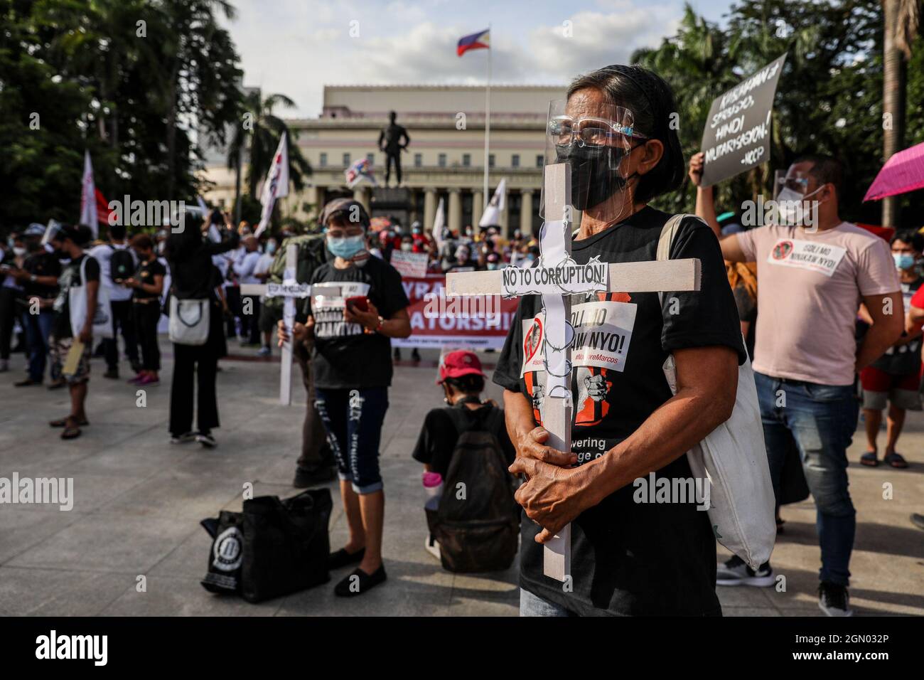 September 21, 2021: An activist holds a cross with a sign during a ...