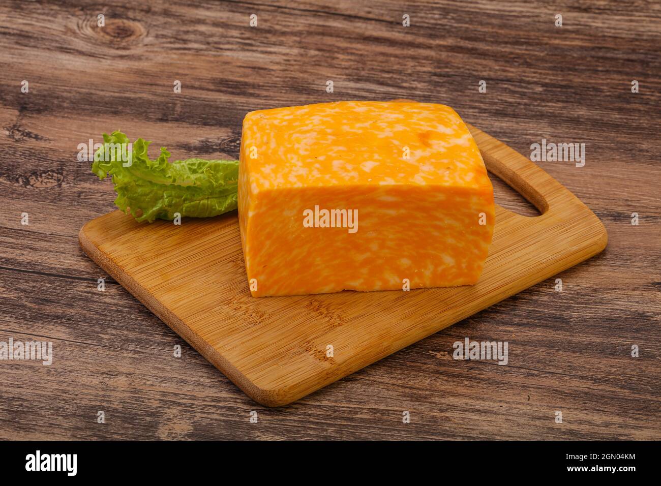 Dairy Marble cheese brick over board Stock Photo - Alamy