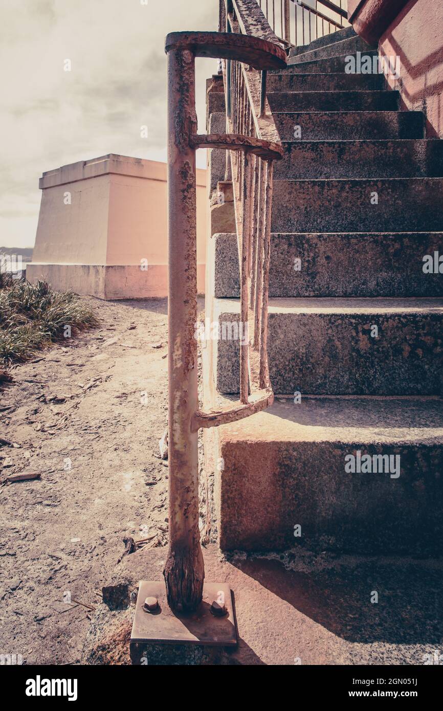 Stairs with a rusty handrail leading up to the Coquille River ...