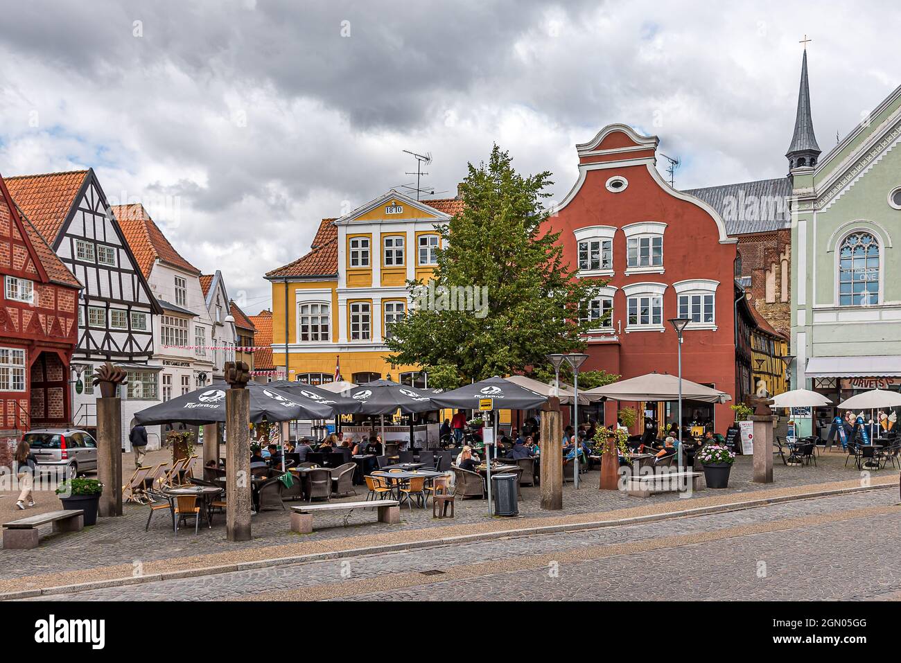 people sitting at a cafe in the center square of Haderslev and the ...
