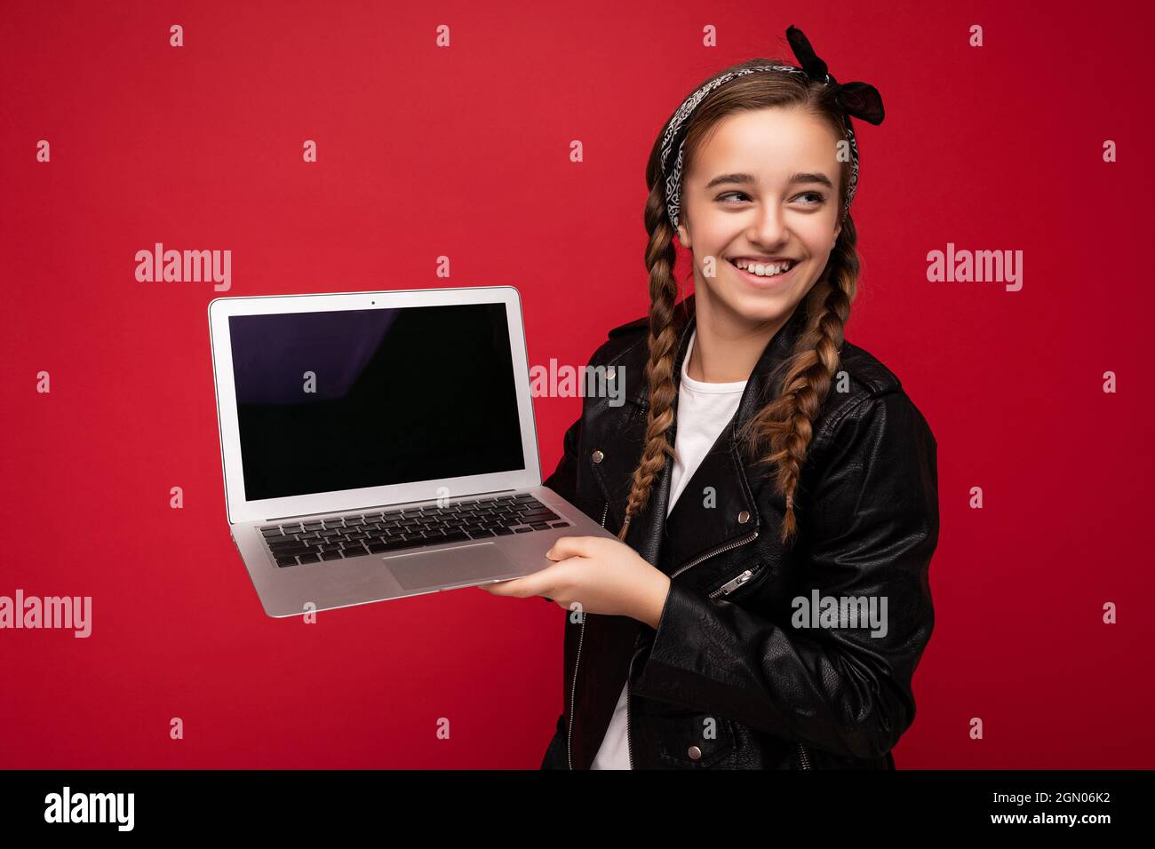 Photo of beautiful happy smiling girl with brunet pigtails holding ...